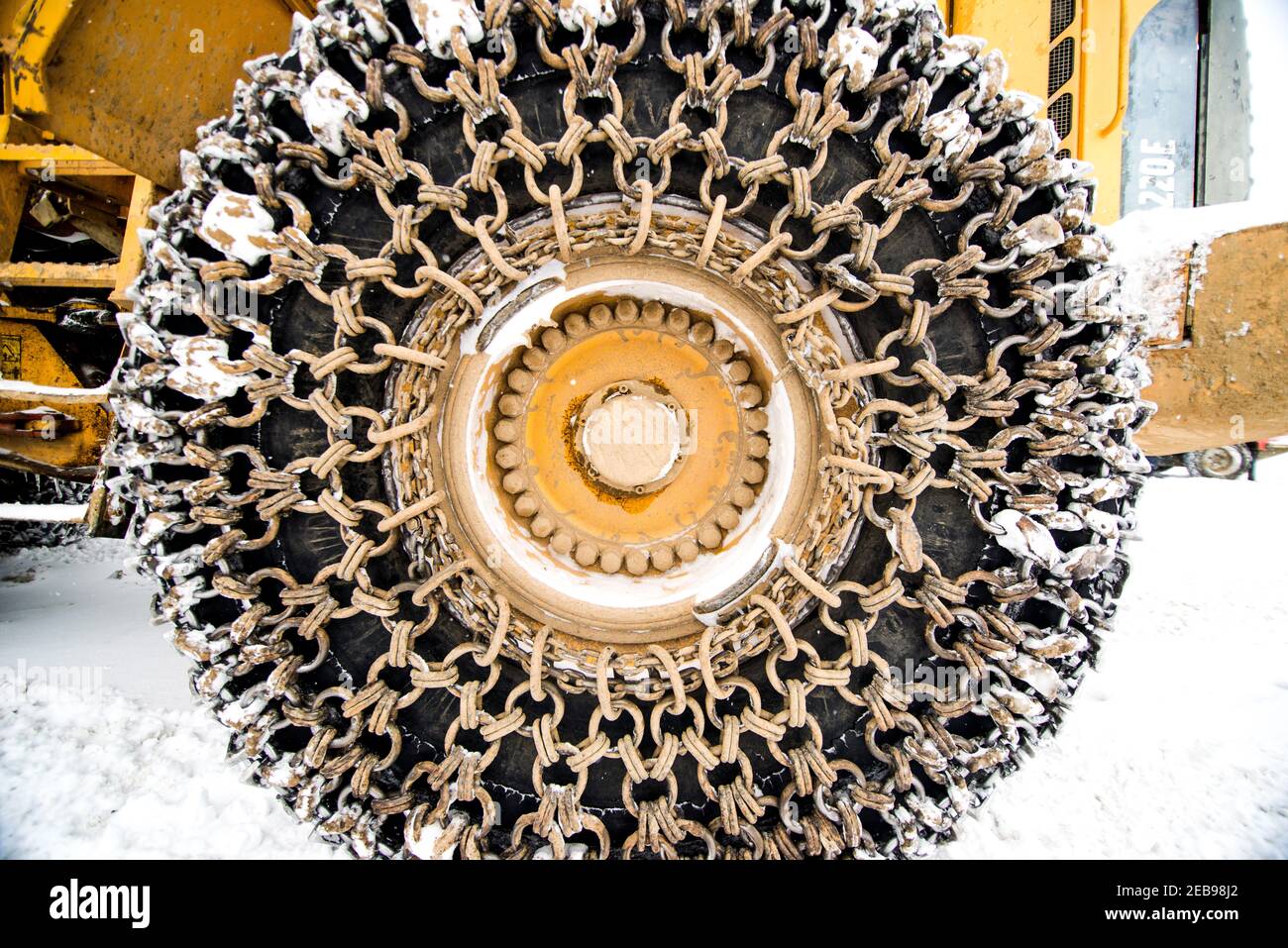 Tractor tires with chains in the snow Stock Photo - Alamy