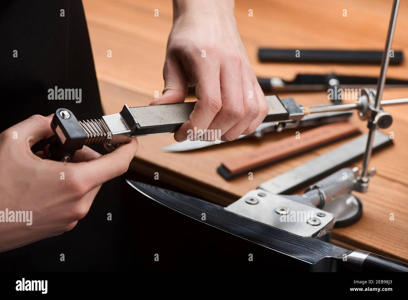 Service man changing a whetstone in a manual sharpener machine Stock ...