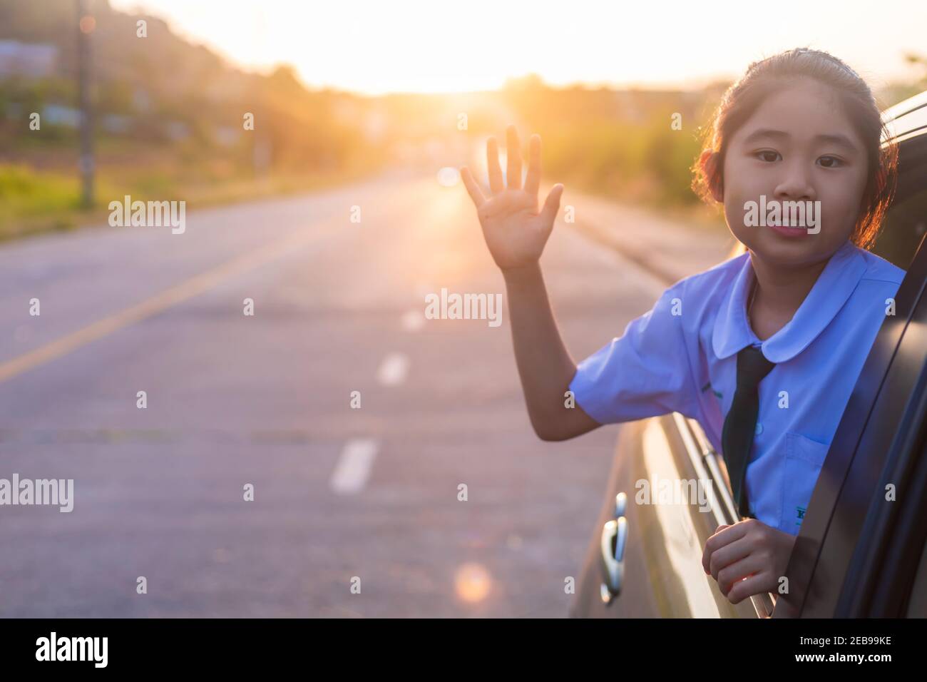 On the way to school, the little girl stretched out his hand from the ...