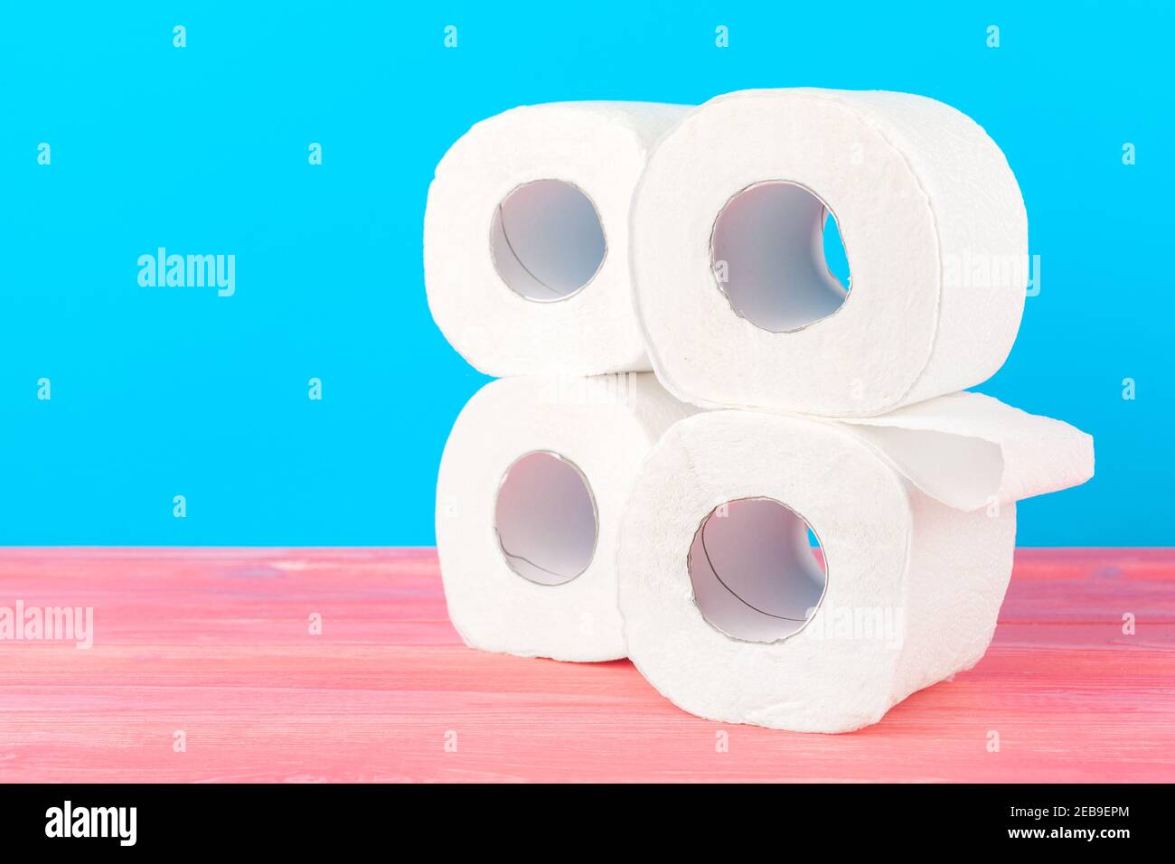 Toilet paper stack on bright blue background Stock Photo - Alamy