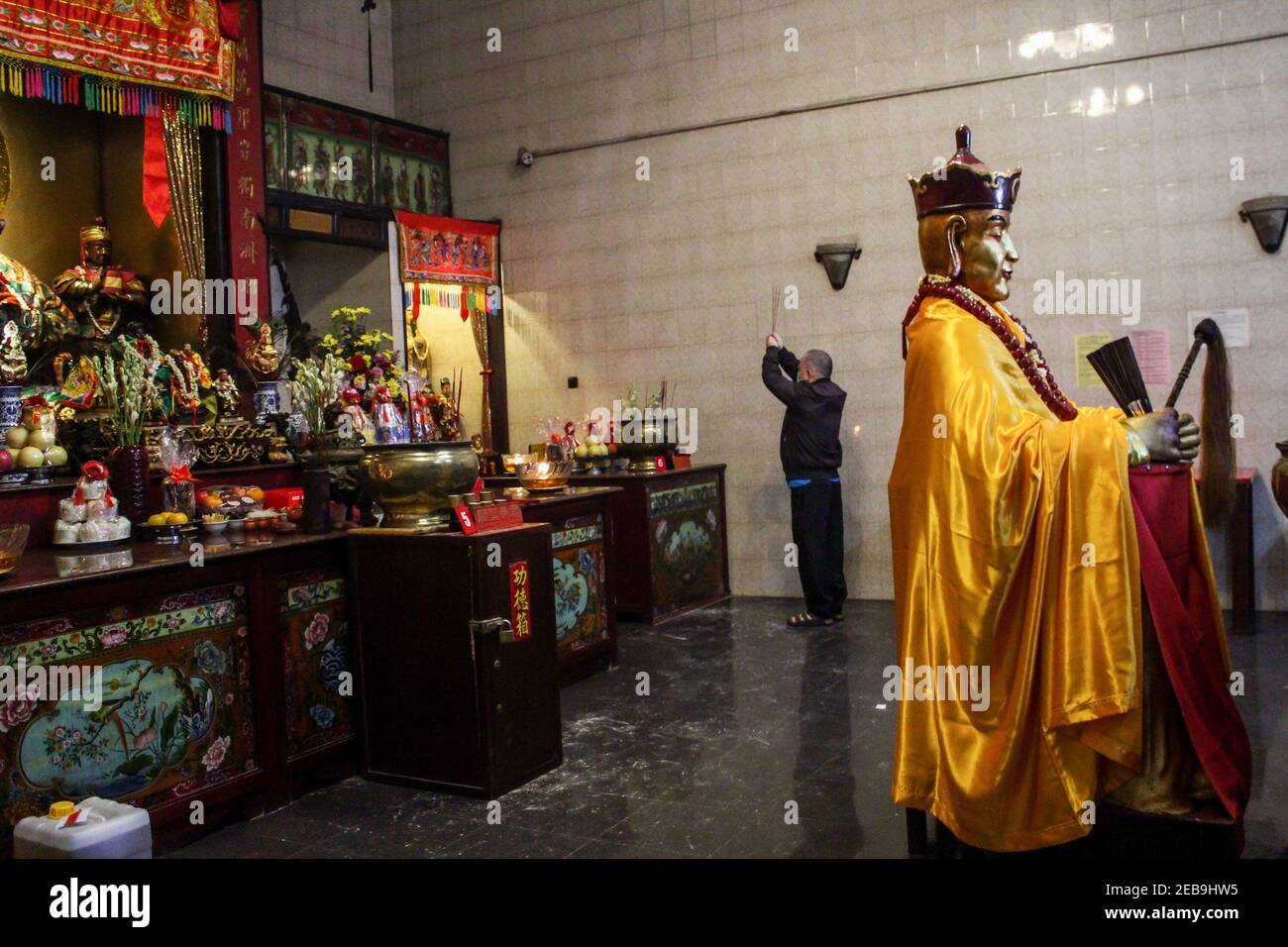 A man prays at the Dharma Ramsi Temple during the Lunar New Year ...