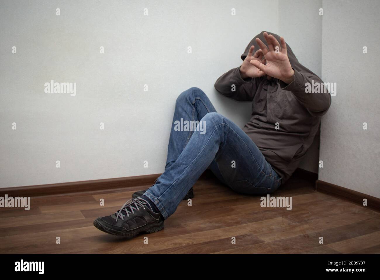 Man Cowering In Corner