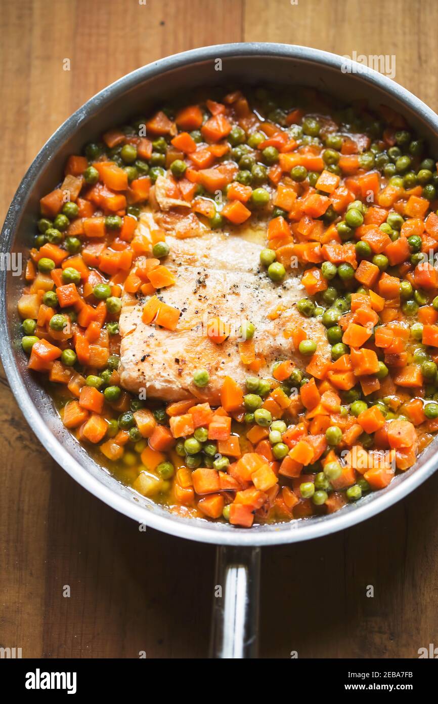 Fried salmon fish with carrot and peas Stock Photo - Alamy