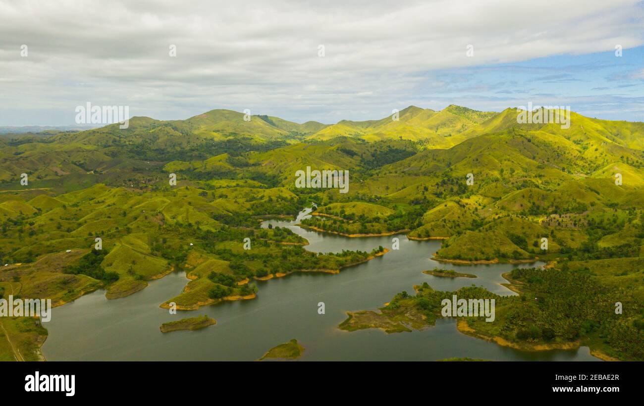 Aerial view of Lake among mountains and hills with rainforest and green ...
