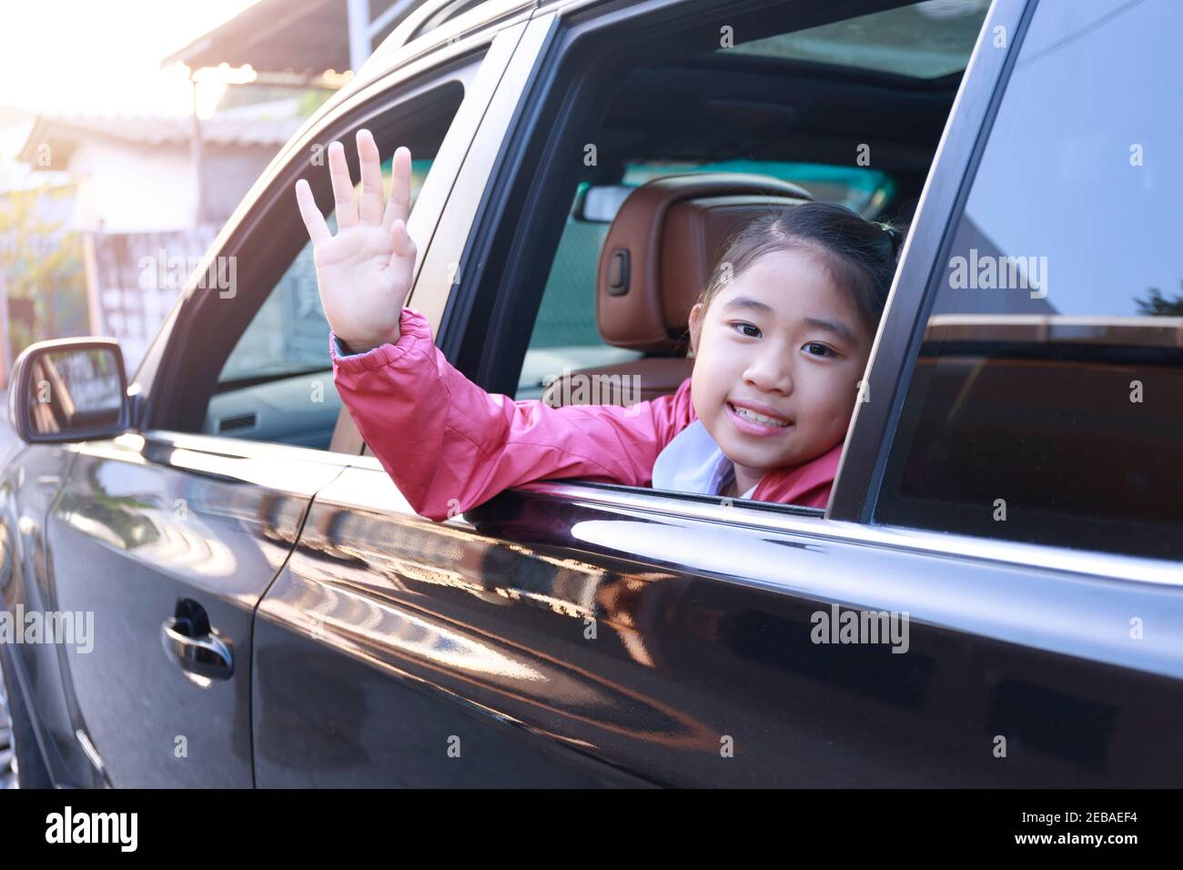 On the way to school, the little girl stretched out his hand from the ...
