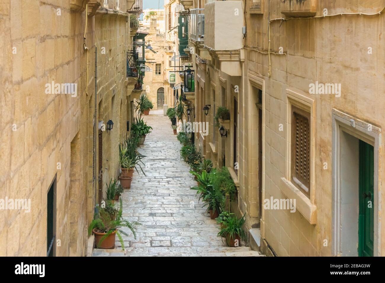 Medieval narrow street of Malta city Birgu. Tiny walking street with ...