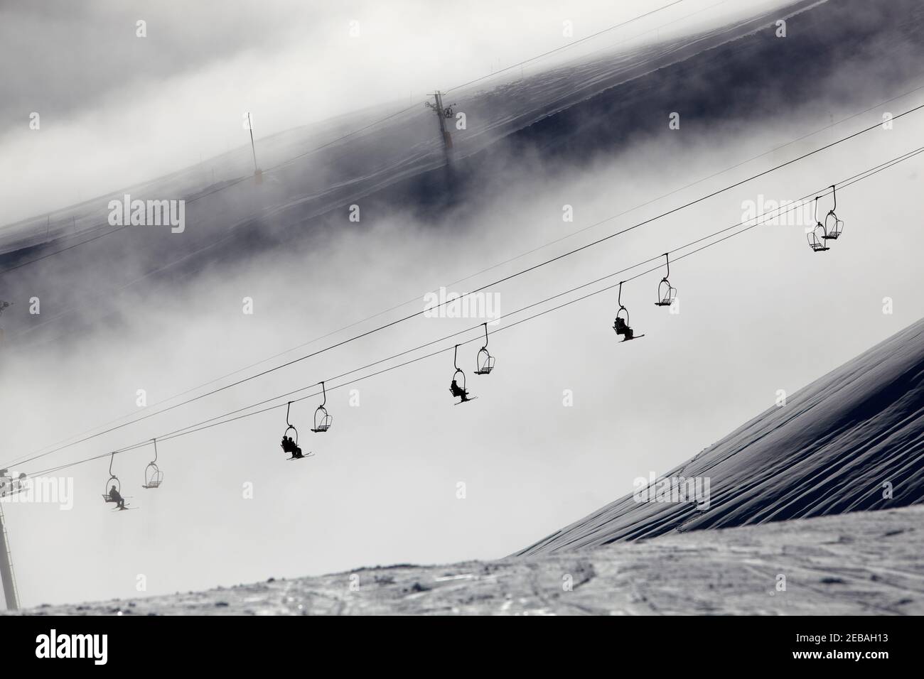 Silhouette skiers riding chair hi-res stock photography and images - Alamy