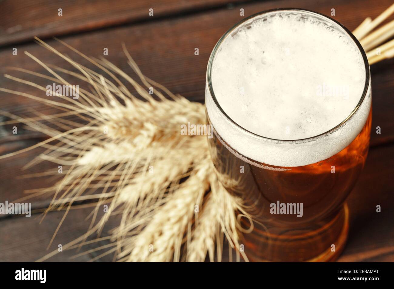 Glass beer on wood background with copy space. Full glass with lager ...