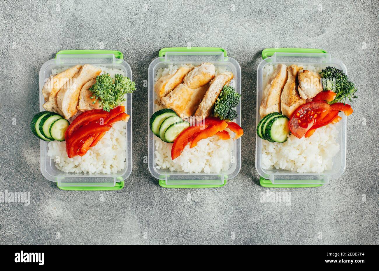 top view of lunch boxes with food on gray background Stock Photo - Alamy
