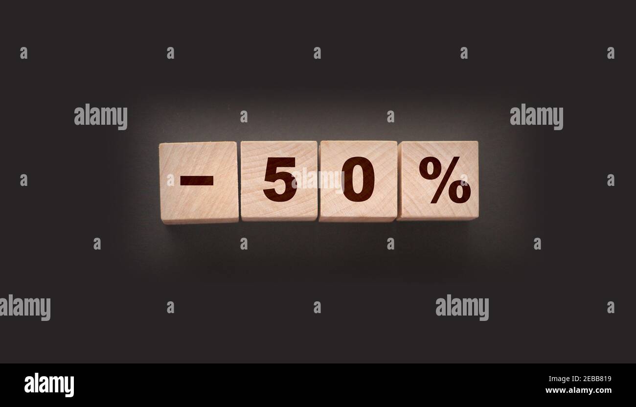 Minus 50% phrase on wooden blocks on black background. Sale business ...