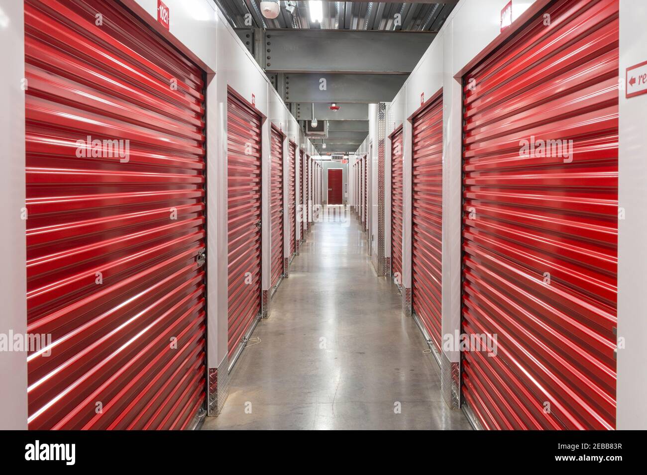 Empty Interior of Self Storage with red doors Stock Photo - Alamy