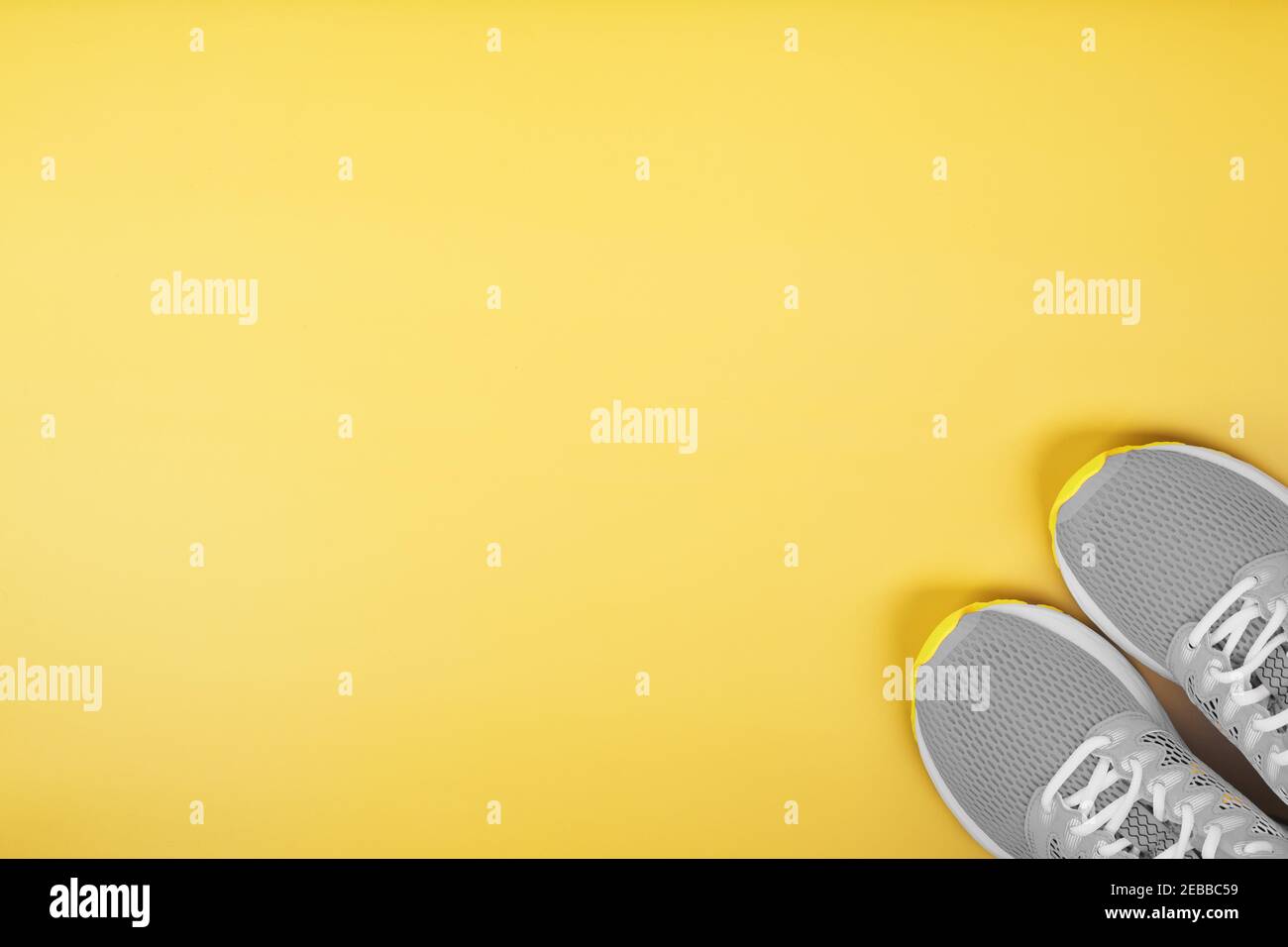 Sports gray sneakers on a yellow background - sport concept, free space ...