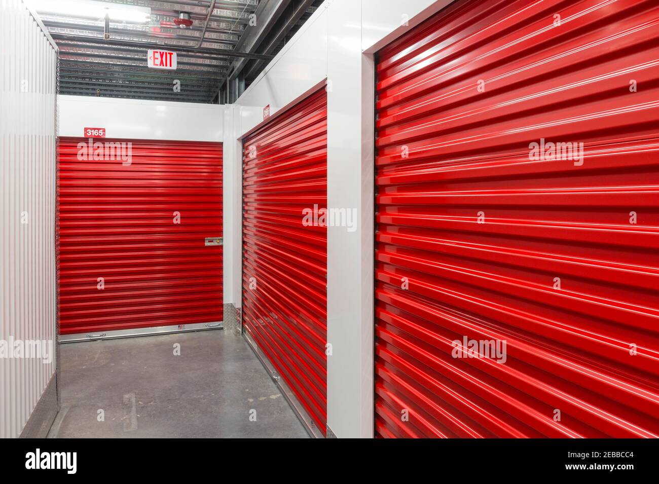 Empty Interior of Self Storage with red doors Stock Photo - Alamy