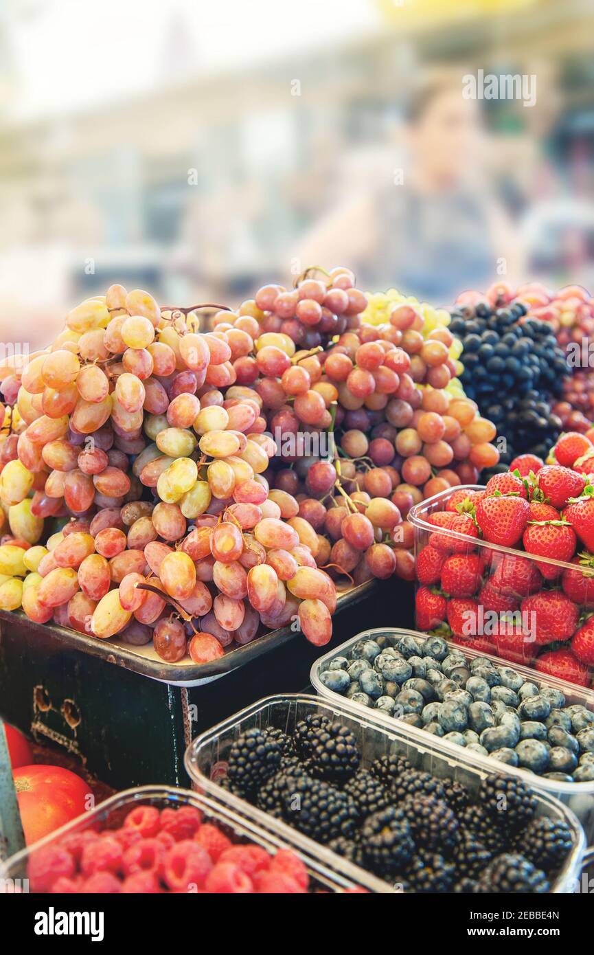 Bunches of grapes on the counter. Green, red bunches of ripe grapes are ...