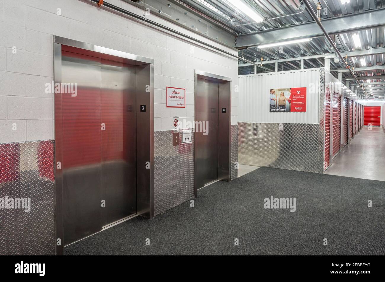Empty Interior of Self Storage with red doors Stock Photo - Alamy
