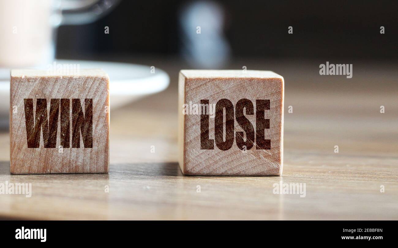 Win and Lose, on wooden cubes and cacao cup. Business success and ...