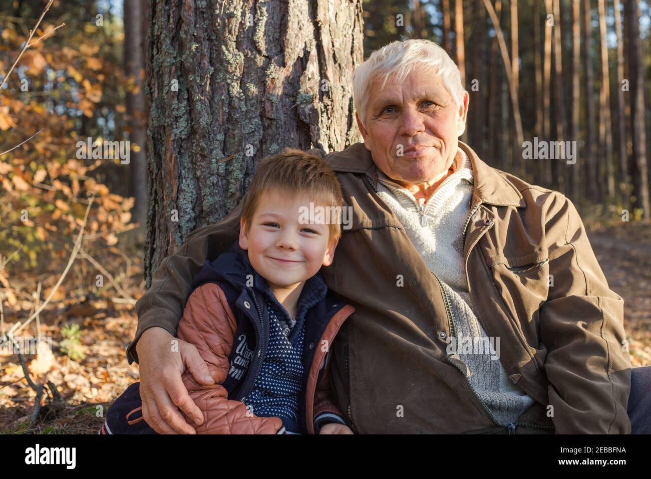 Happy child with Grandfather playing at the forest. Grandpa retiree ...