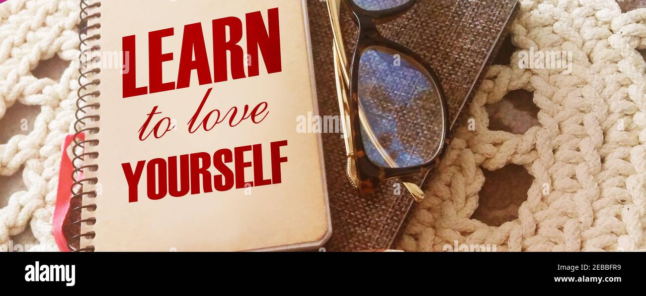 Learn to love yourself words on a notebook with glasses and pen ...