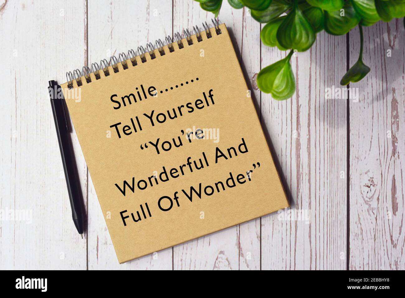 Motivational and inspirational quote written on brown notebook with ...