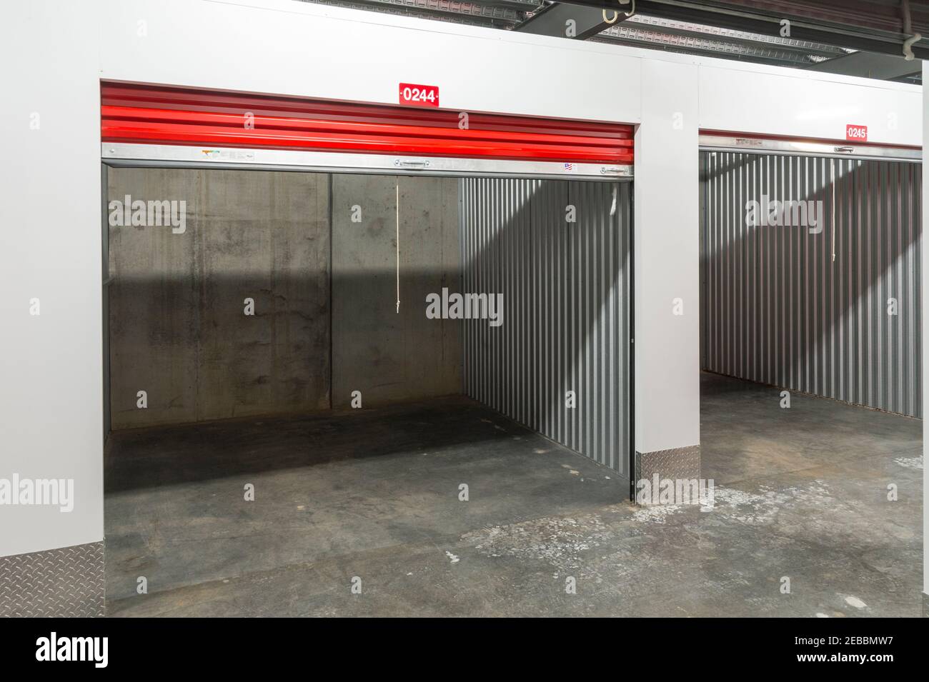 Empty Interior of Self Storage with red doors Stock Photo - Alamy