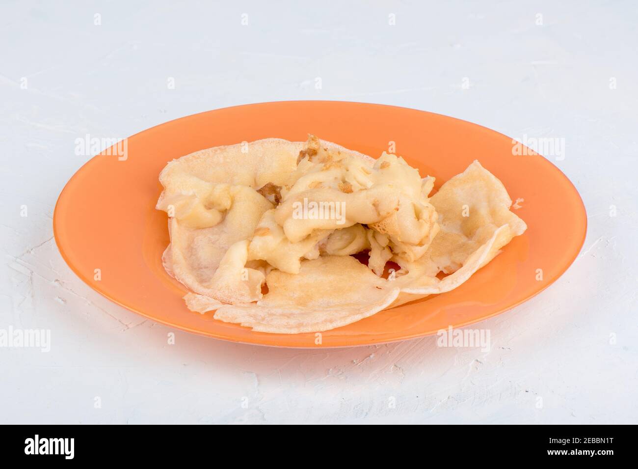 Missing first pancake on a plate. The first pancake is lumpy. The first ...