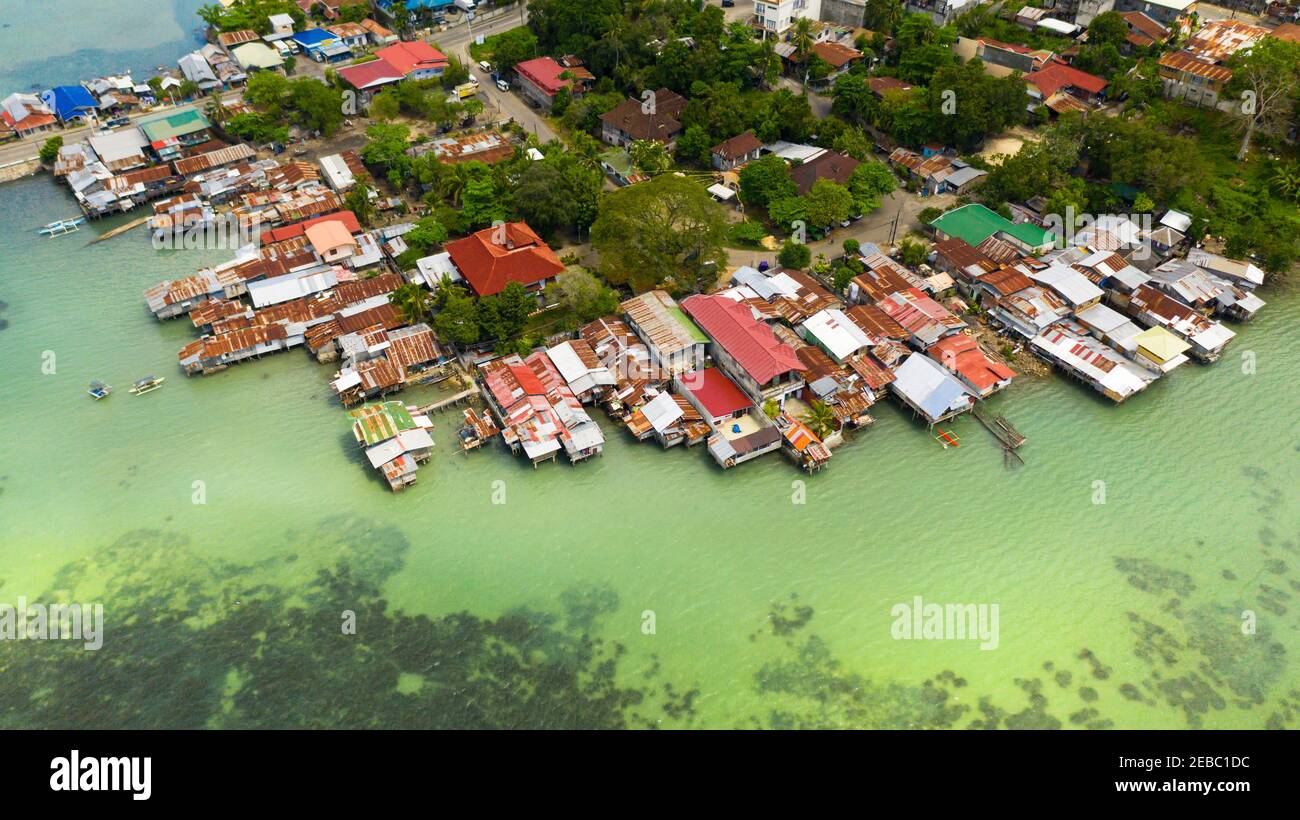 Village of fishermen with houses on the water, with fishing boats in ...