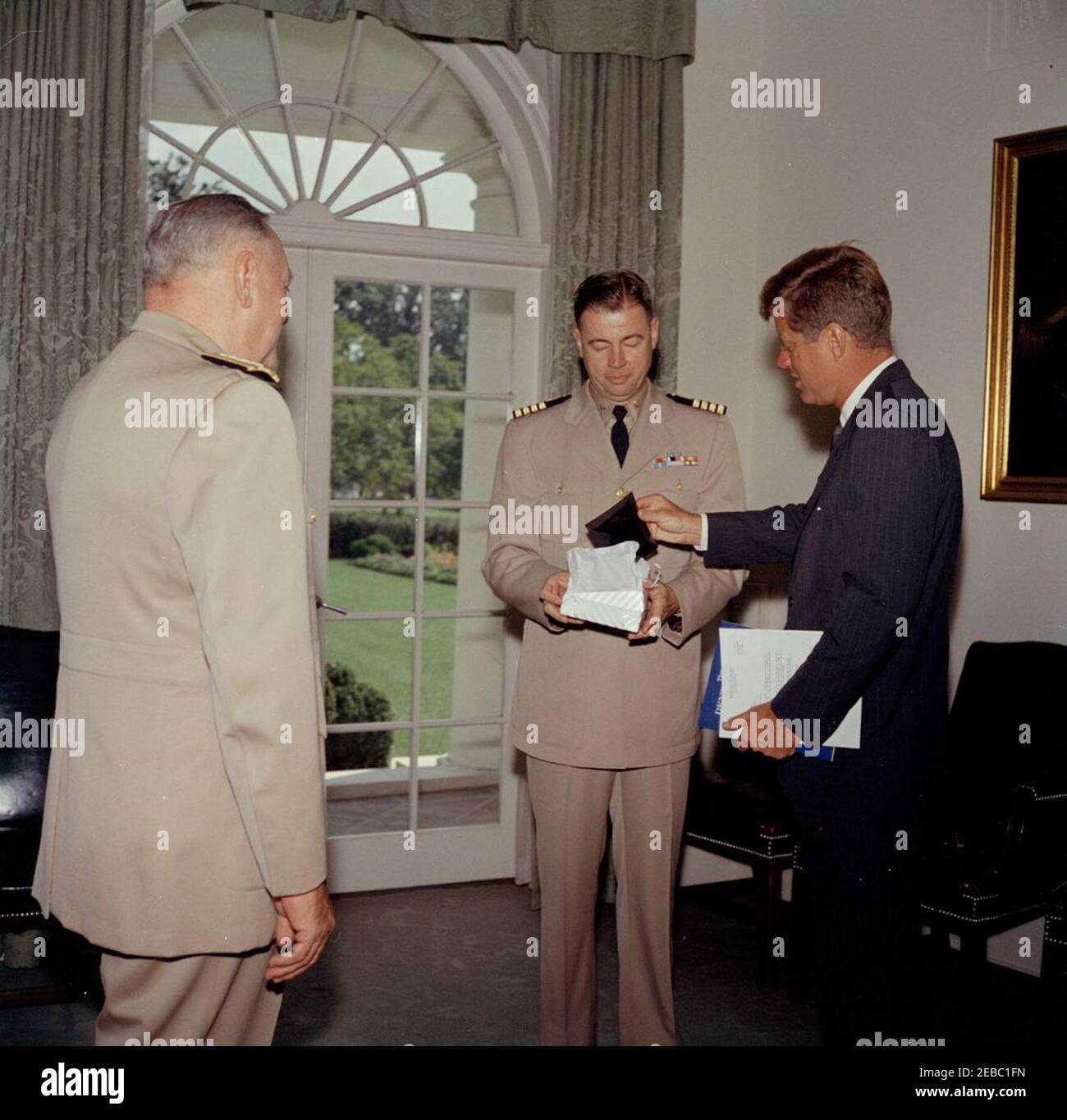 Visit of naval officers. President John F. Kennedy visits with two ...