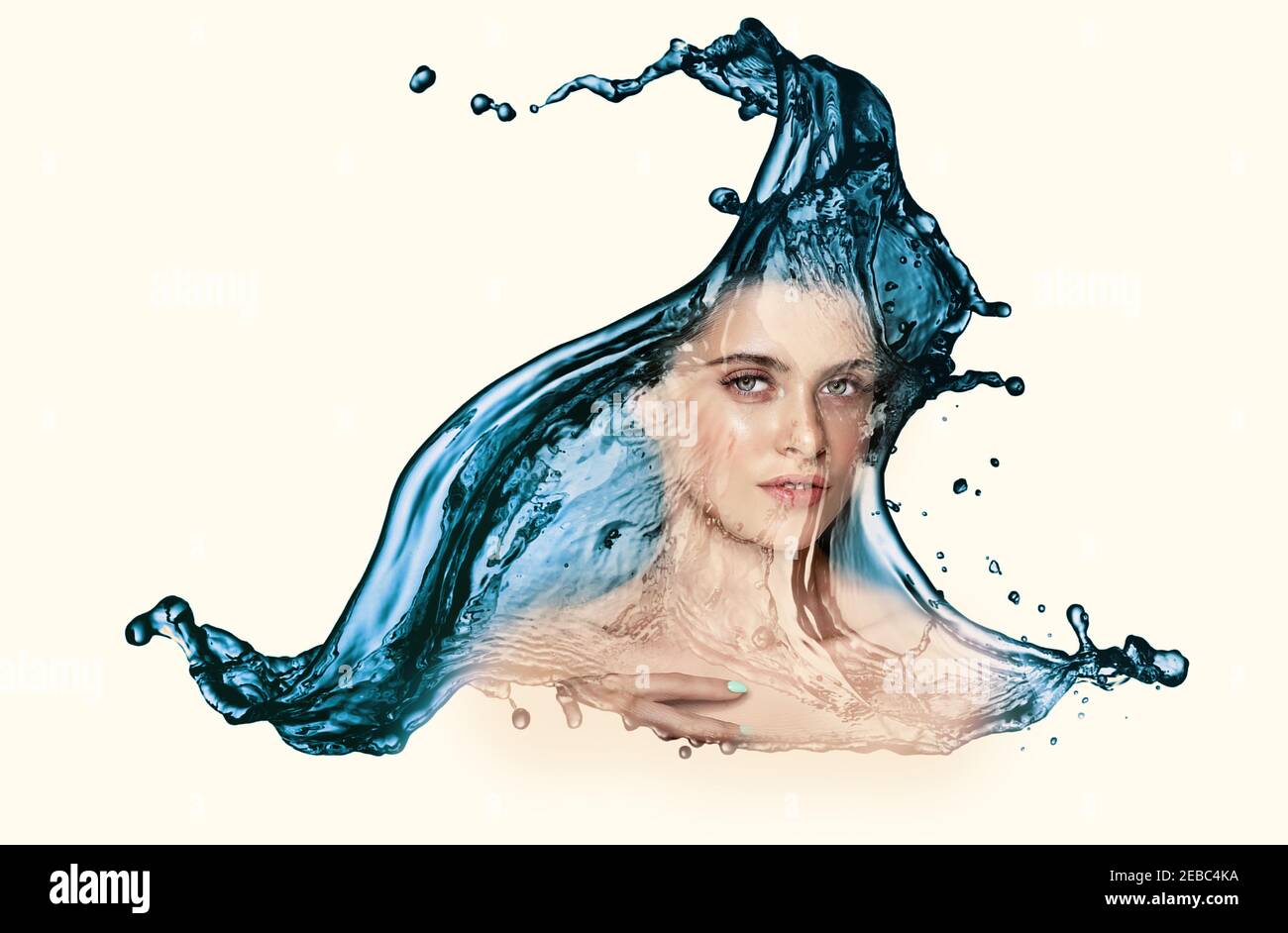 Reflection of a beautiful brunette girl in a water splash on a beige ...