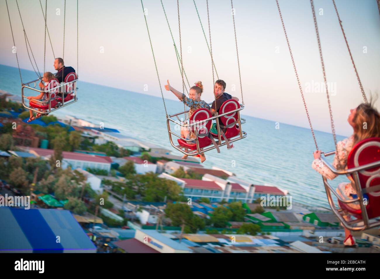 People have fun enjoying the air carousel in the amusement park Stock ...