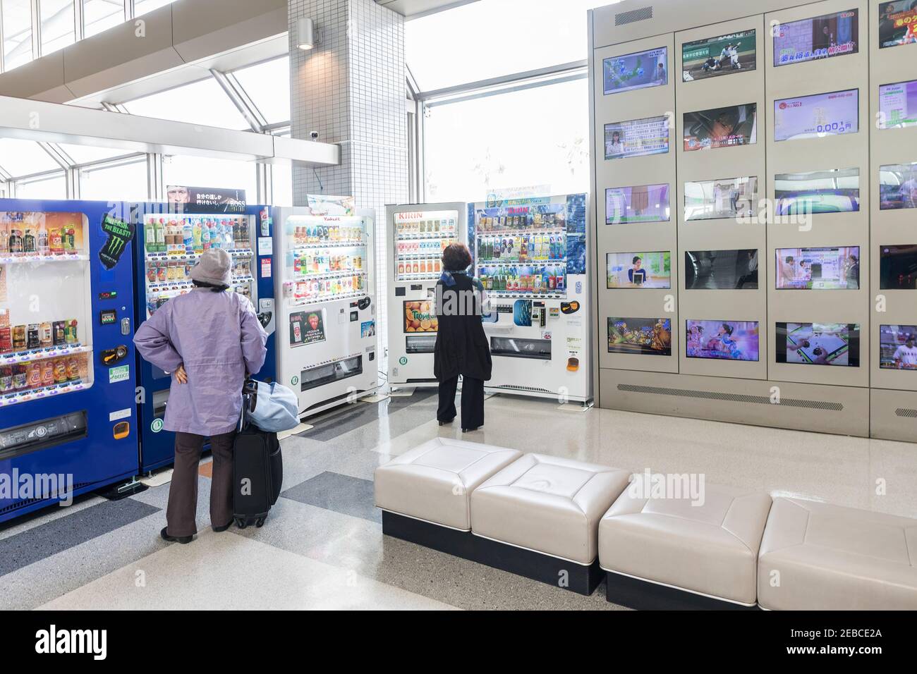 Vending machines for food and drink and television screens at airport ...