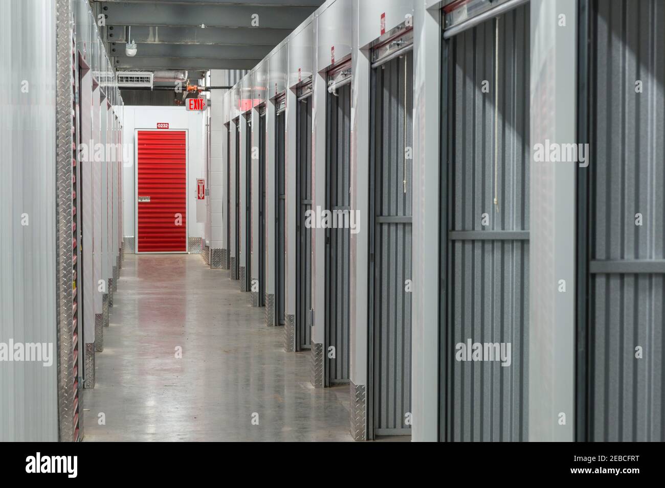 Empty Interior of Self Storage with red doors Stock Photo - Alamy