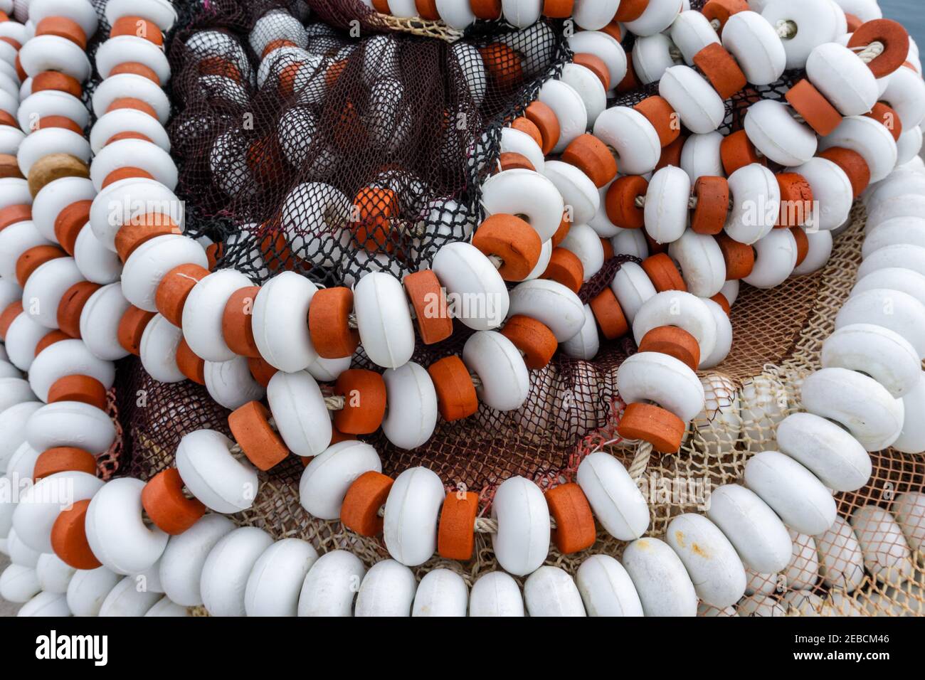 A close up view of fishing and trawling nets bunched together on a dock ...