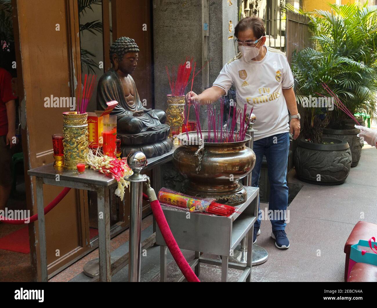 A Chinese lit an incense honoring Buddha during the Lunar New Year ...