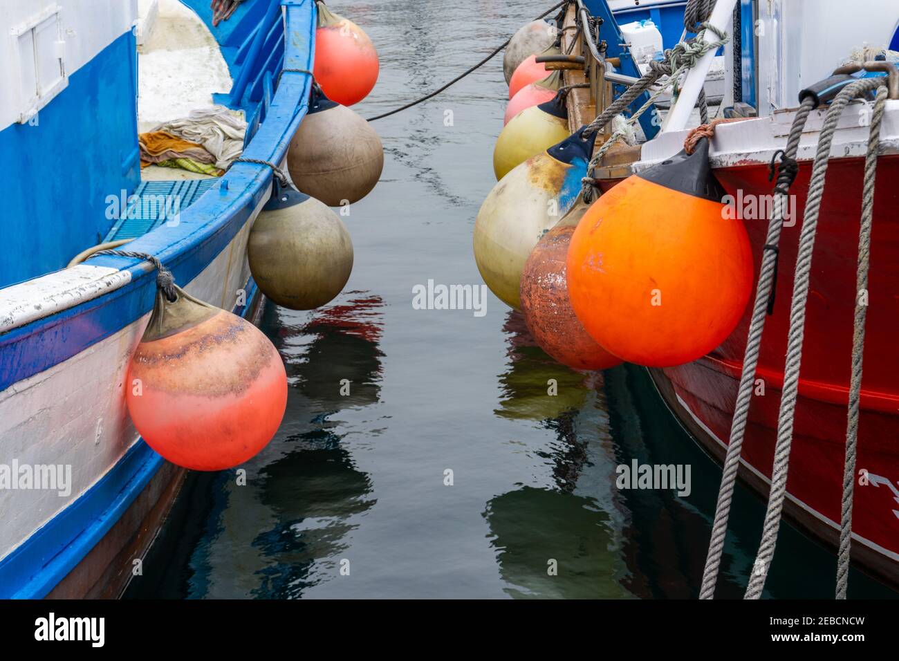 A close up colorful fishing boats and industrial port and harbor in ...