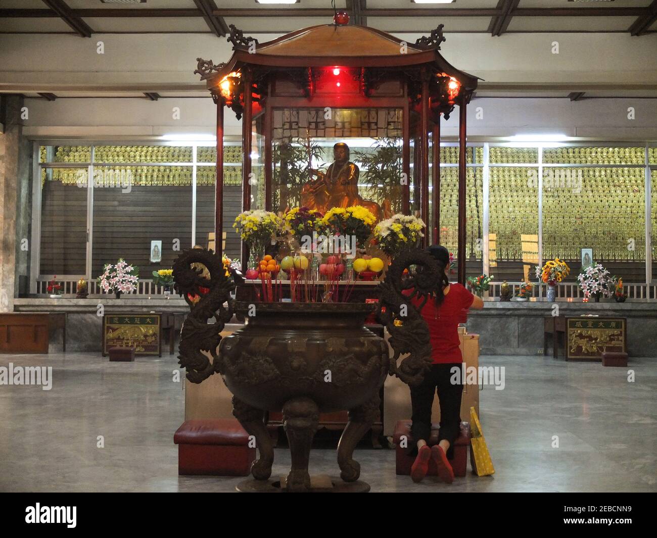A female Chinese offering prayers during the Lunar New Year ...
