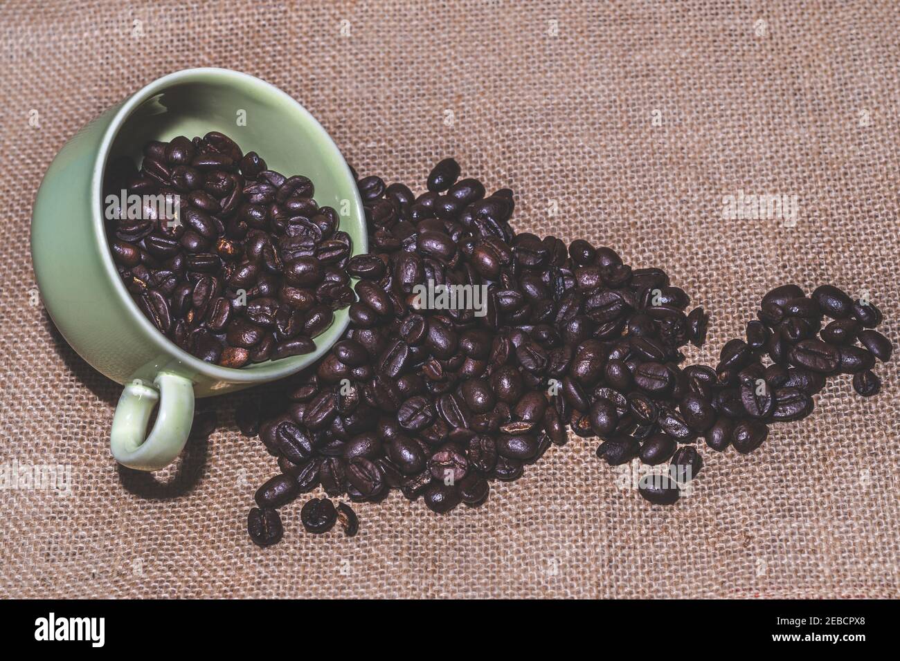 Closeup shot of a cup and freshly roasted coffee beans Stock Photo - Alamy