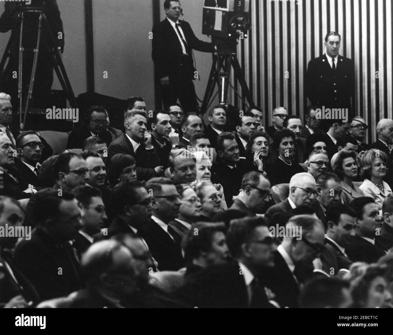 Press Conference, State Department Auditorium, 4:00PM. Audience listens ...