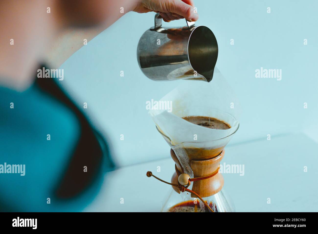 Hand pouring hot water into a coffeemaker Stock Photo - Alamy