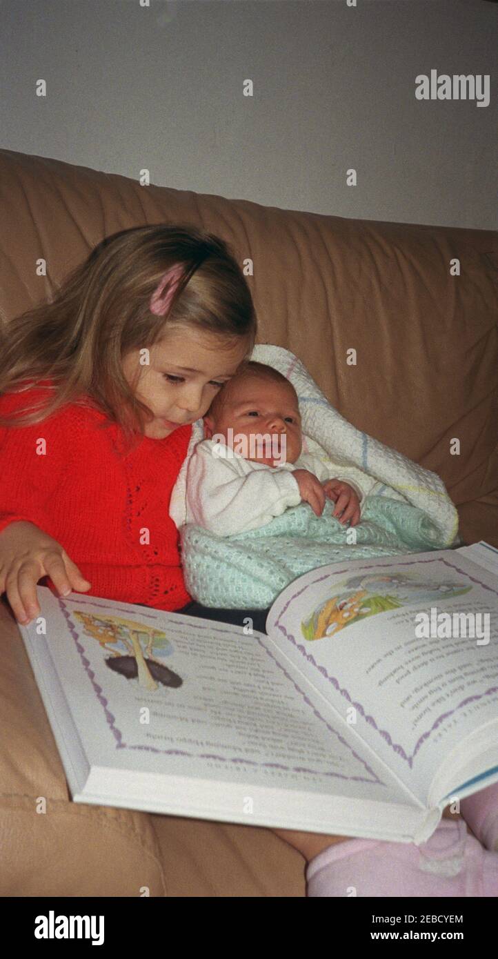 small child reading to baby Stock Photo - Alamy