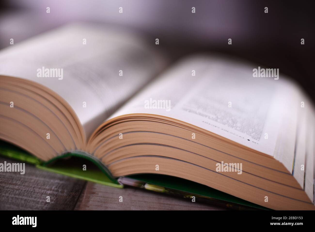 Composition with open book on the table Stock Photo - Alamy