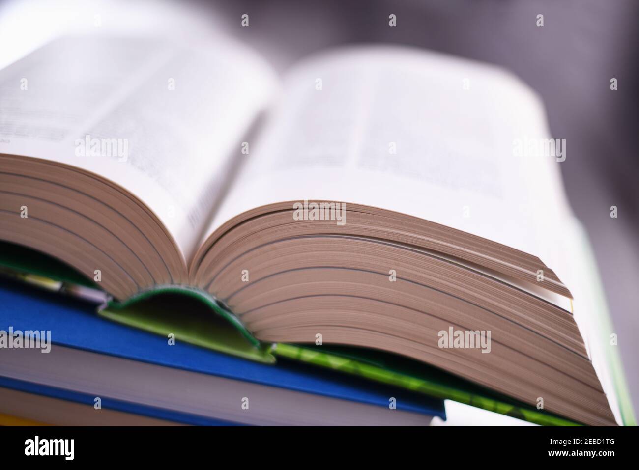 Composition with open book on the table Stock Photo - Alamy