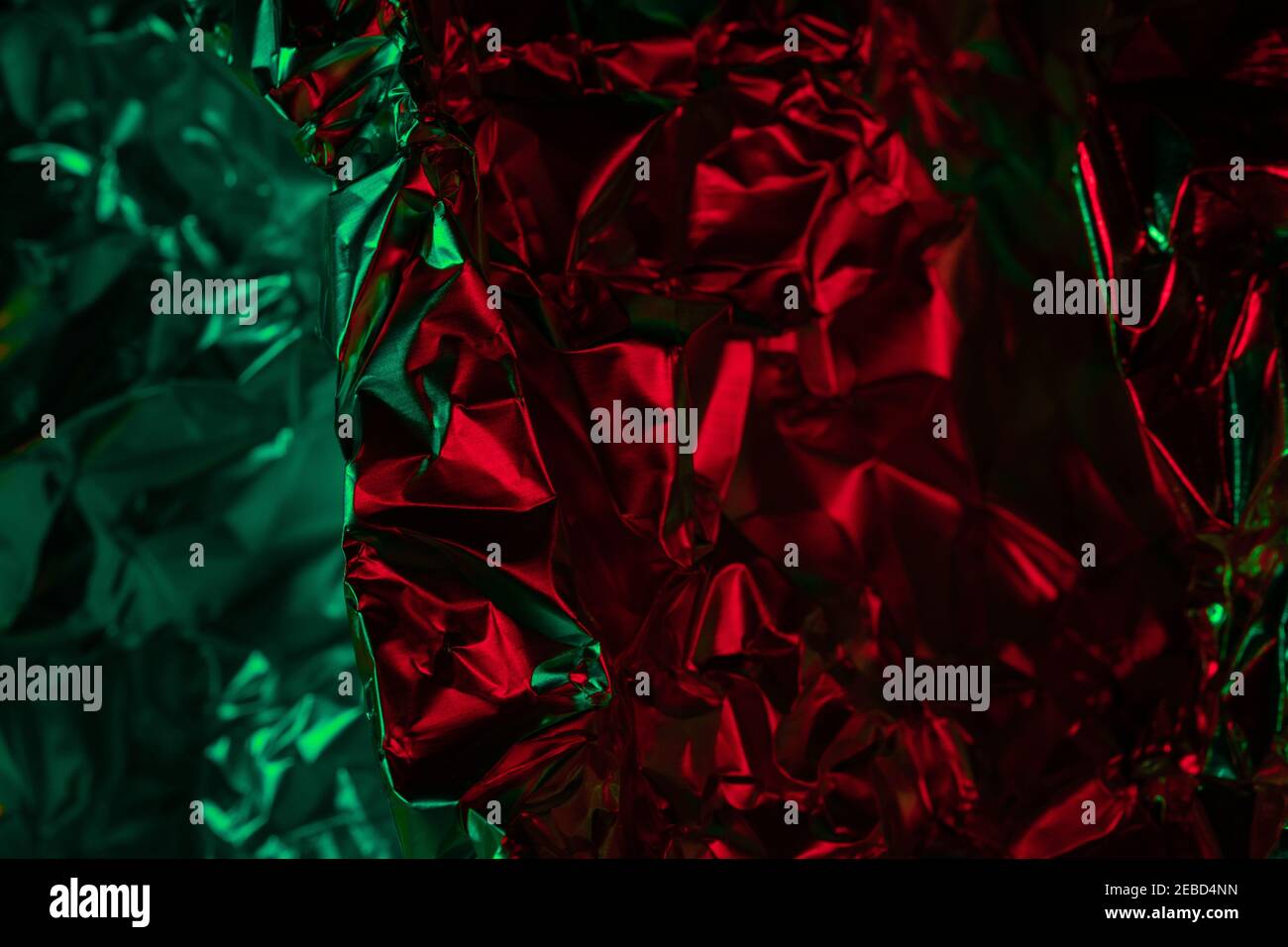 Closeup of colorful shiny crumpled wrapping paper under the lights ...