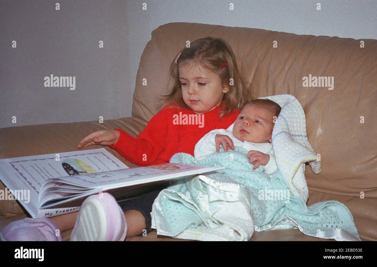 small child reading to baby Stock Photo - Alamy