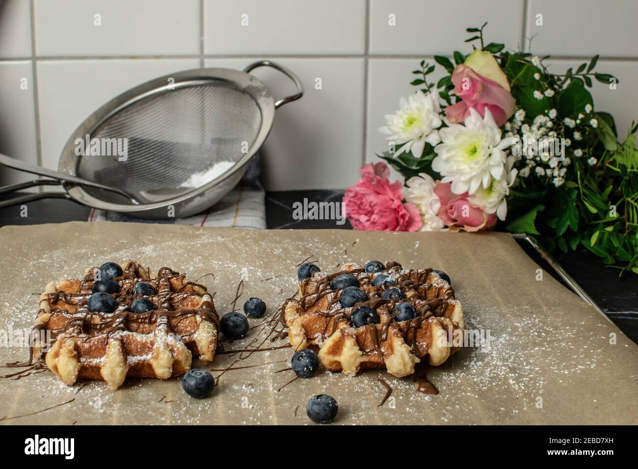 Closeup of waffles with blueberries topped with chocolate on the ...