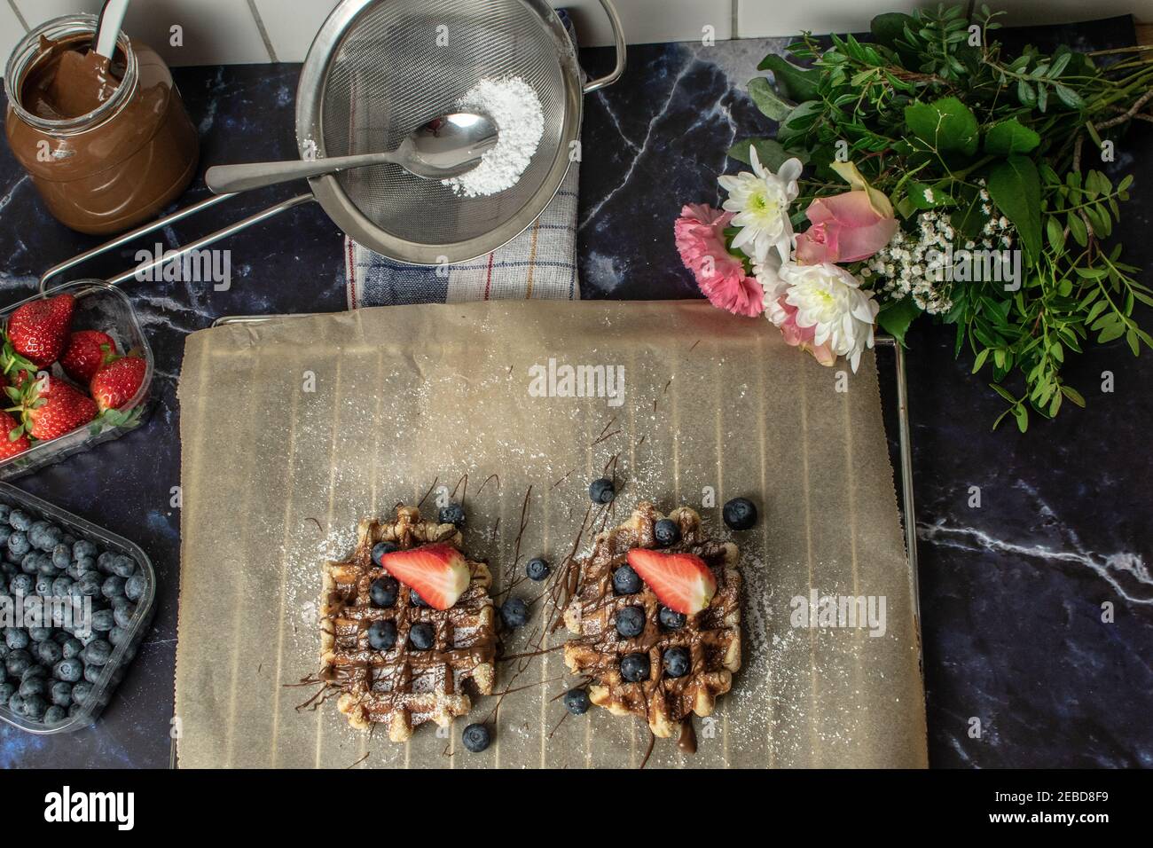 Top view of waffles with strawberries and blueberries topped with ...