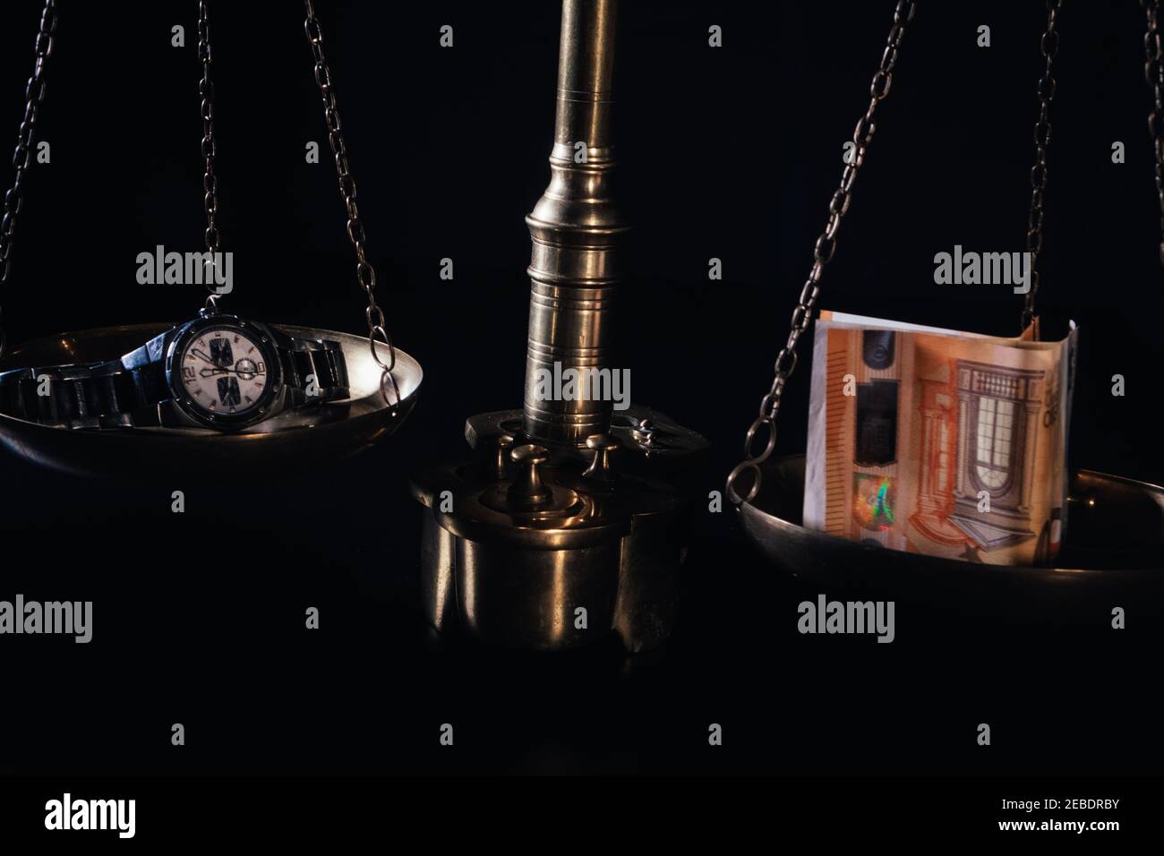 Watch and banknotes on vintage scales - the value of time and money ...