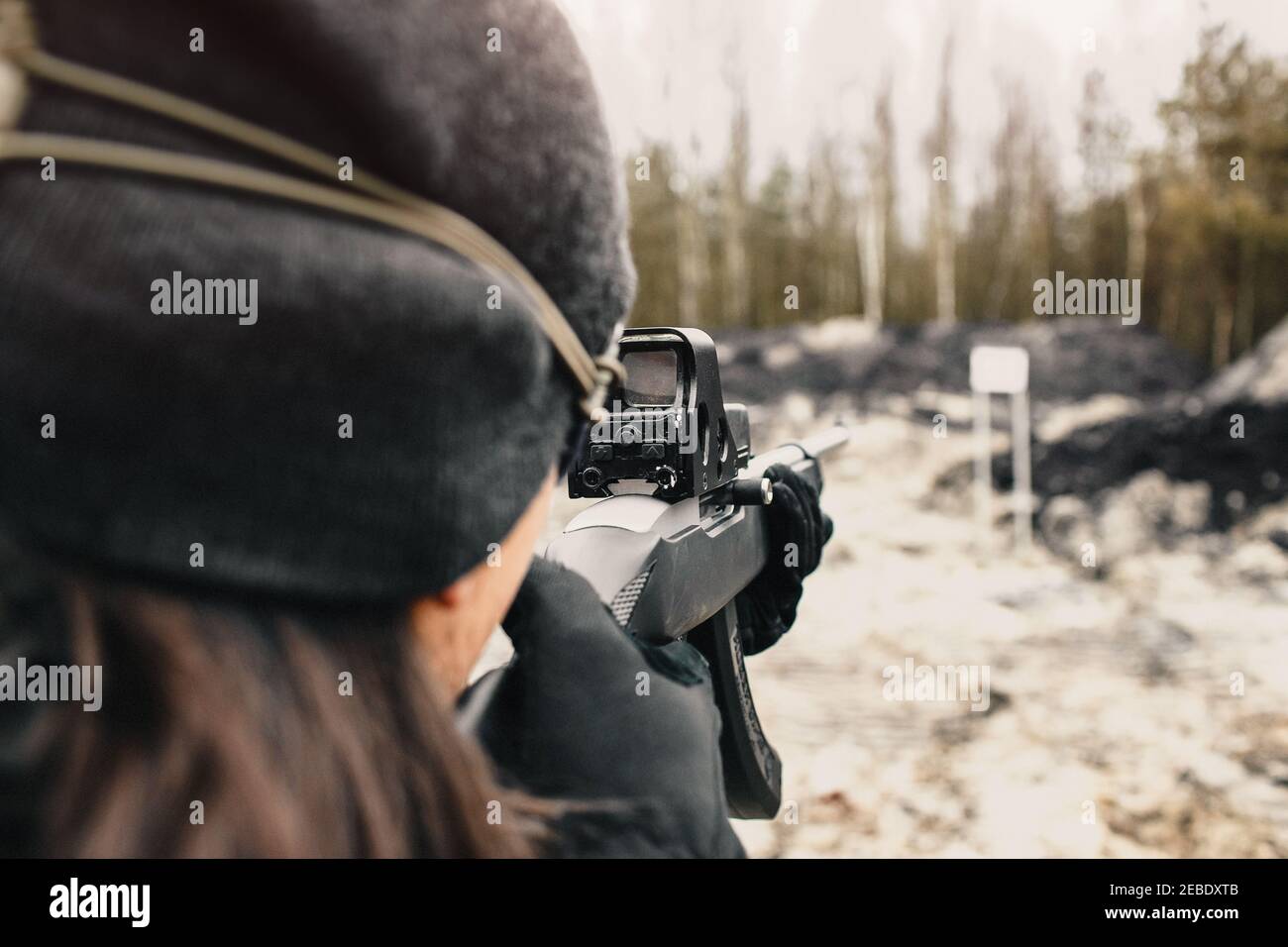 A guy shoots from a hunting rifle on the shooting range in the desert ...