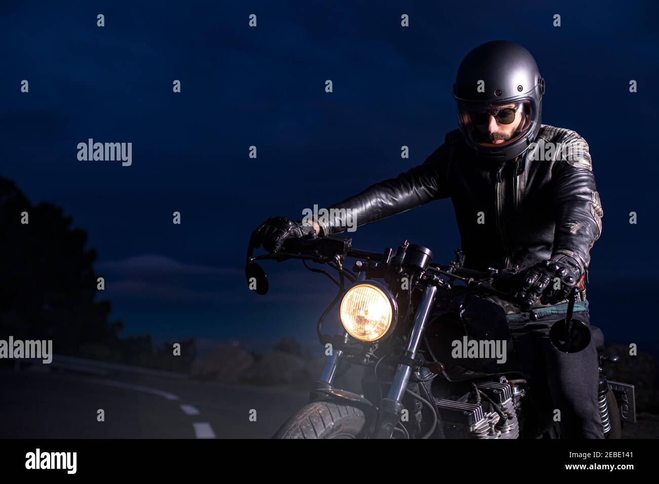 Motorcyclist on his choper motorcycle at night on the road Stock Photo ...