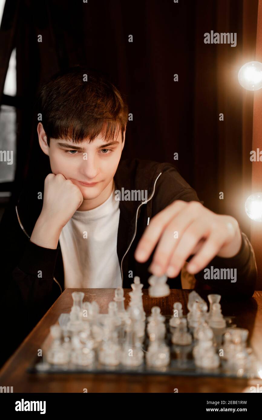 Young guy playing glass chess Stock Photo - Alamy