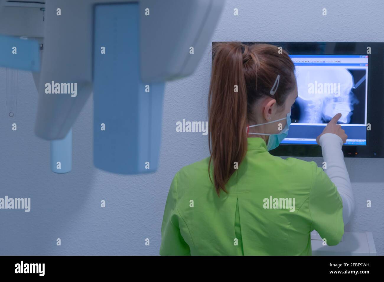 Woman dentist with mask checking an x-ray scan in dental clinic Stock ...